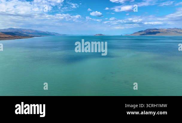 The beautiful azure of the waterscape and sky reflecting in it. Fluffy ...