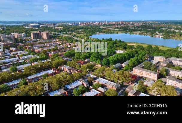 Rising over the green neighborhood of New York with a big pond ...
