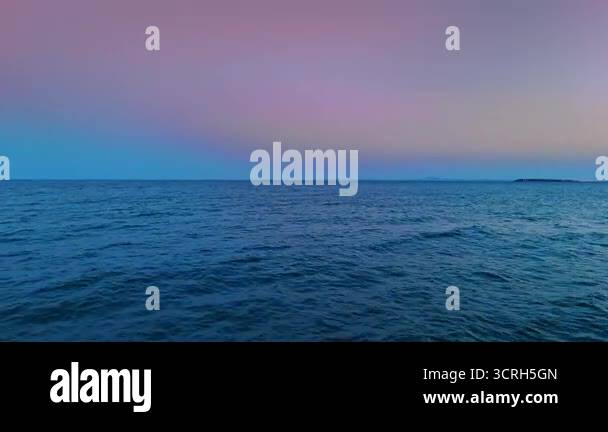 Open sea horizon under a pink and blue sky. Beautiful seascape with ...