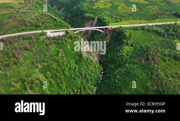Cars ride by the beautiful Hurricane Gulch Bridge. Drone footage ...