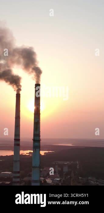 Big factory tubes smoking on sunset. Huge industrial ecology smog ...