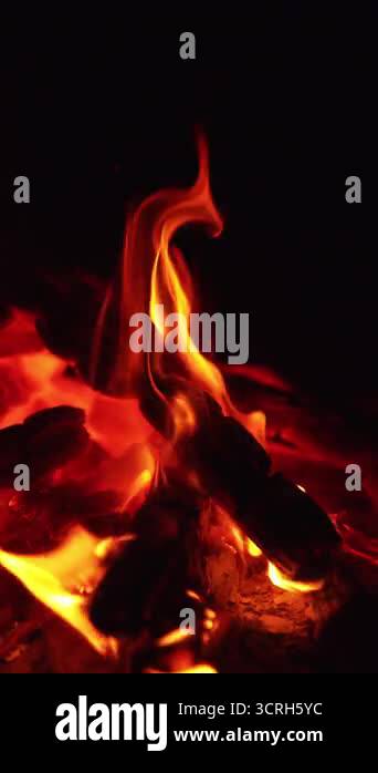 Burned out wood in the bonfire. Beautiful smoldering embers in a pile ...