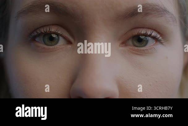 Close-up portrait of ladys eyes looking at camera blinking with no ...