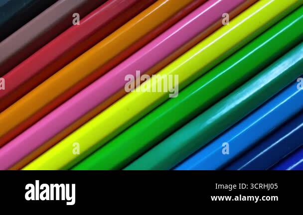 A vibrant, close-up video of a row of colored pencils arranged in a ...