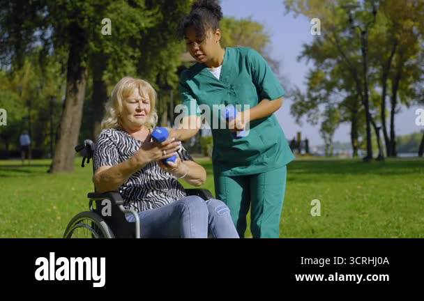 Motivated elderly woman in wheelchair with age-related mobility ...