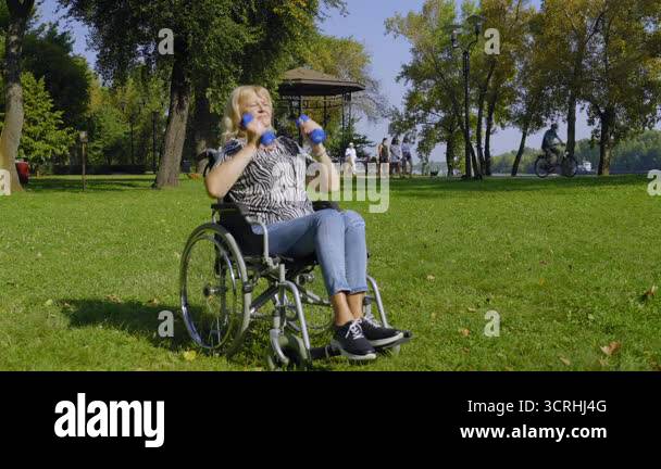 Motivated attractive senior woman in wheelchair with age-related ...