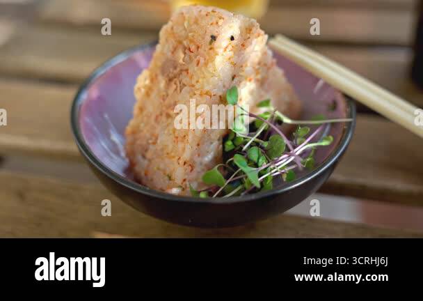 Close up of Japanese onigiri rice meal with tuna, chilli and yellow ...