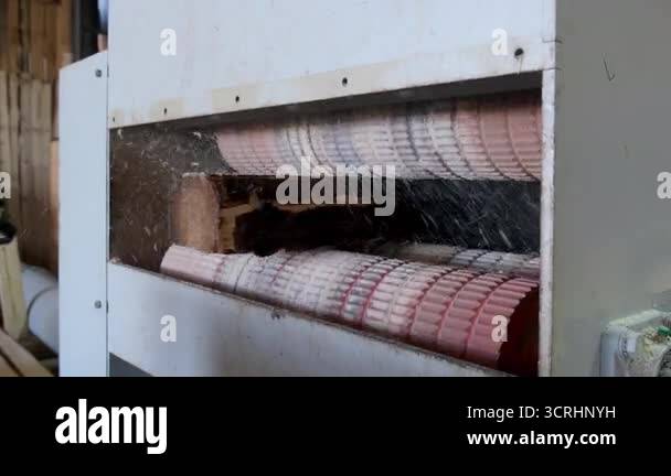 Logs moving from cutting machine at woodworking plant cut in wood ...