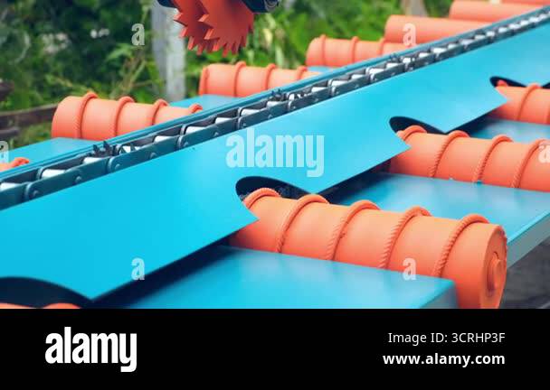 Part of conveyor belt with roller conveyor to move separate wood boards ...