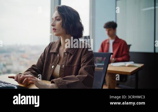 Serious brunette working corporate office typing computer closeup. Two ...