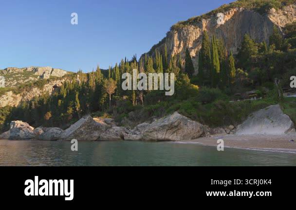 Calm morning sea near rough sand beach at Liapades Corfu, Greece - sun ...