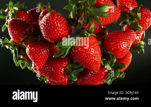 Super Slow Motion of Flying Strawberries Isolated on Black Background ...