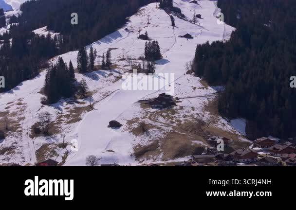 Aerial view of snowy slopes and ski lifts in Gstaad, Switzerland, a ...