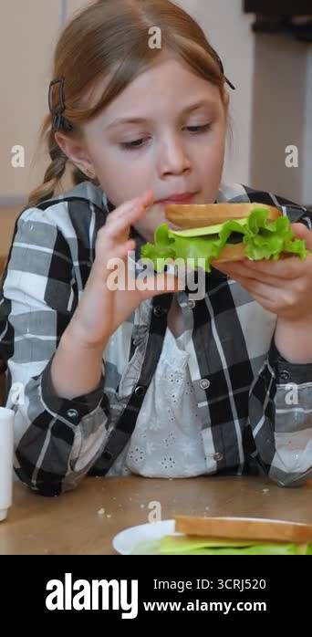 Caucasian European cute teen girl eating sandwich with slice of ...