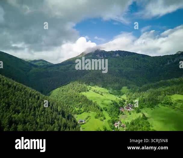 Aerial Hyperlapse spring Alps Mountains,fluffy clouds,green meadows ...