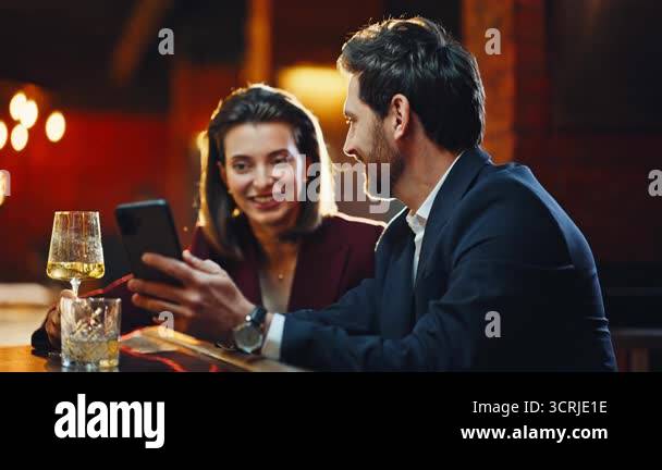 Flirting lady talking man at night celebration in pub lounge. Smiling ...