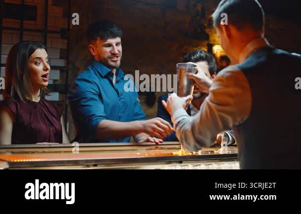Partying friends resting at night bar having fun closeup. Barista ...