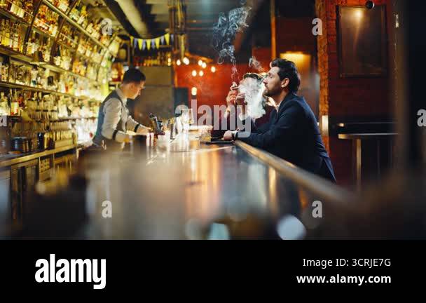 Fashionable man woman having quiet cigarette break resting in warm ...