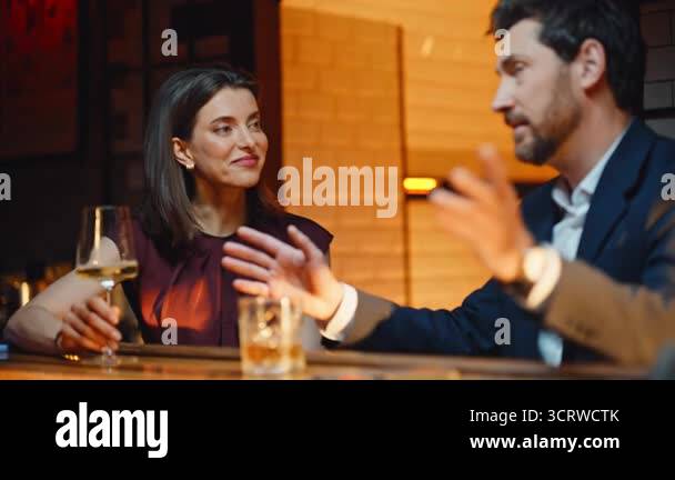 Elegant couple talking bar counter at evening closeup. Two people ...