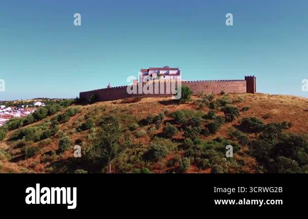 Stone battlement wrapping monastery in ancient town. Fortified wall ...