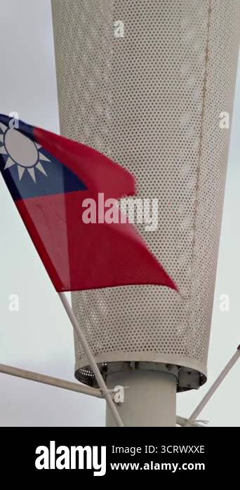 Vertical Slow motion of Taiwan flag blowing in the wind on a tall pole ...
