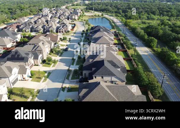 Local highway FM 407 separates new development suburban homes with pond ...