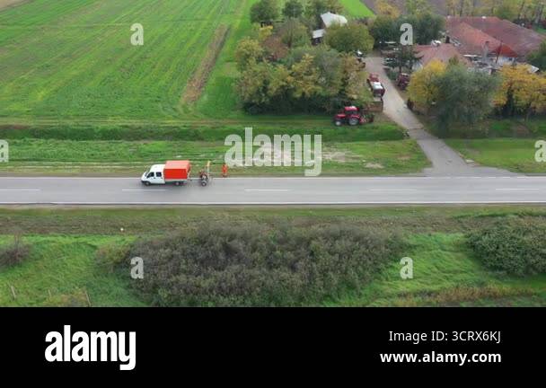Above view, dolly move lateral, slider over three tractors as they are ...