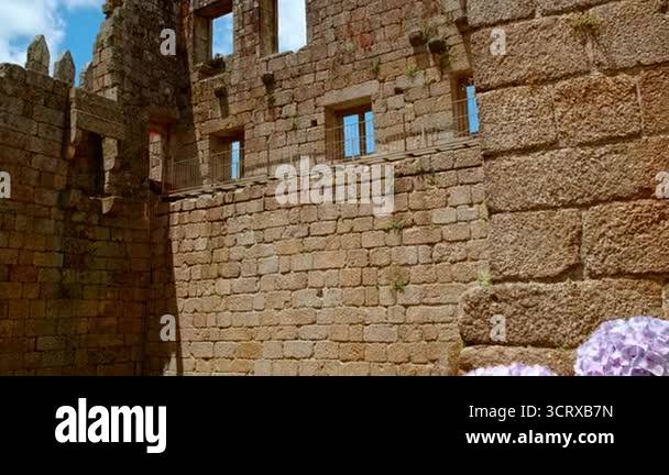 The Medieval Castle of Guimaraes crowns a granite outcrop with imposing ...