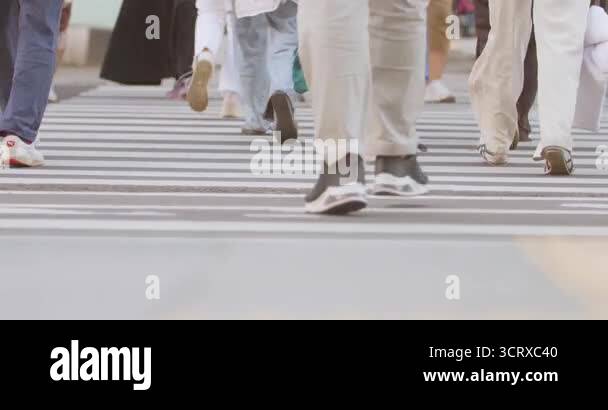 Close up of office workers' feet crossing at a zebra crossing in ...