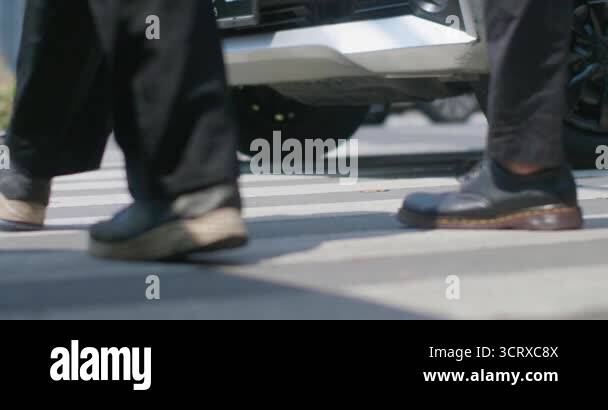 Close up of office workers' feet crossing at a zebra crossing in ...