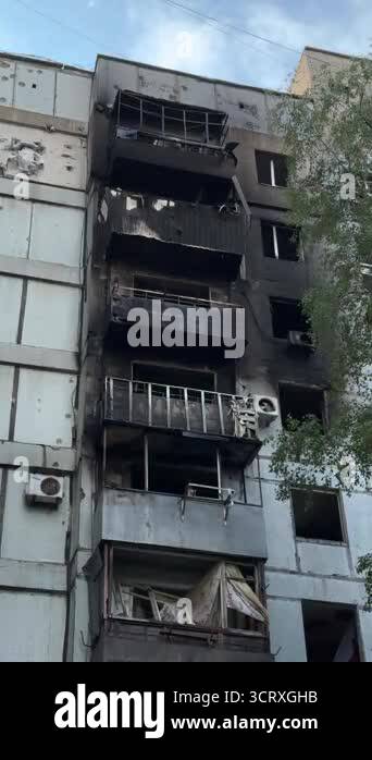 A damaged residential building with burnt-out balconies after shelling ...