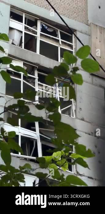 A damaged residential building with burnt-out balconies after shelling ...