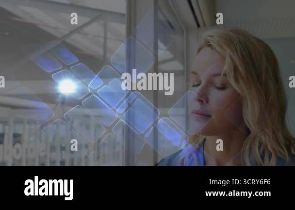 woman standing by window in modern atrium, activating digital tech graphics evoking deep insight ...