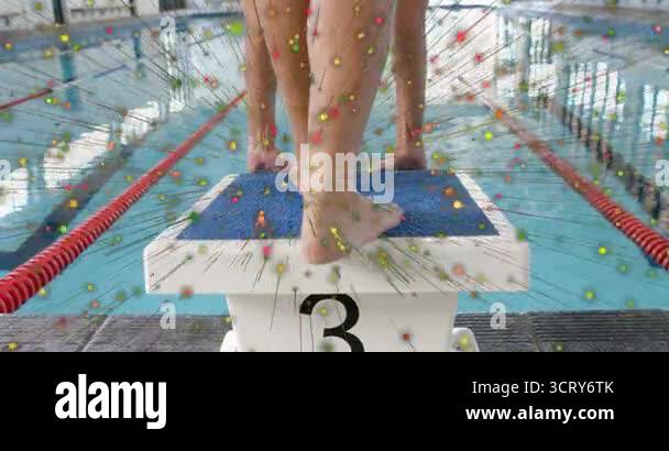 Female swimmer gripping blue block 3 shifting weight and launching into ...