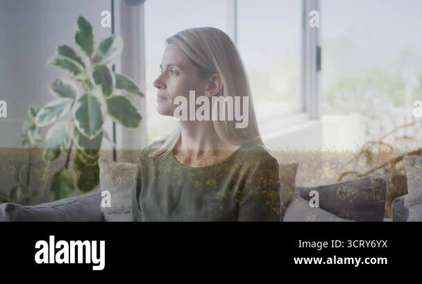 Woman feeling cough tickle on sofa by window, covering face and ...
