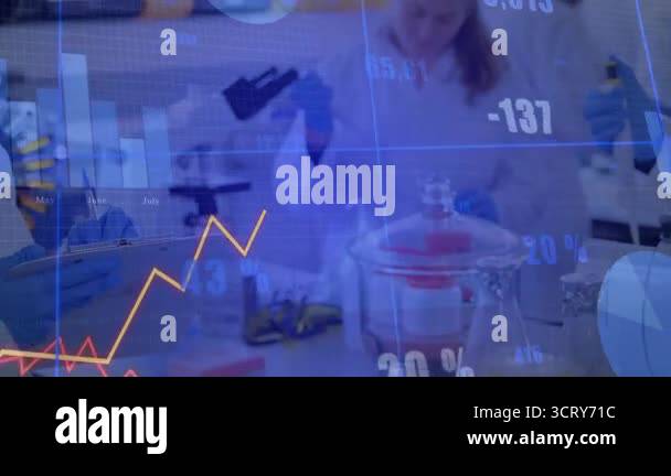 Lab scientist pipetting into vessel while colleague logging ...