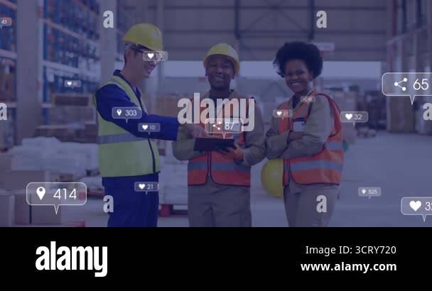 Warehouse workers pointing tablet and activating floating social icons ...