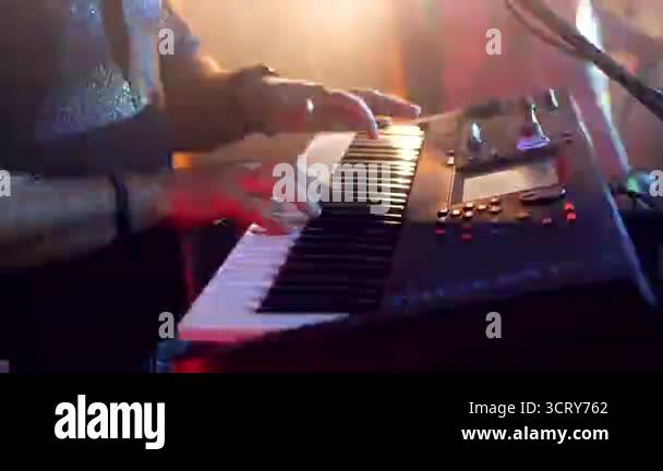 A keyboard player giving a live performance during a concert ...