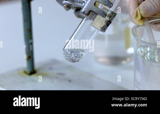 Chemical reaction producing gas bubbles in test tube Stock Video ...