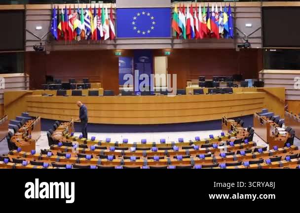 A wide-angle view of the European Parliament assembly hall with rows of ...