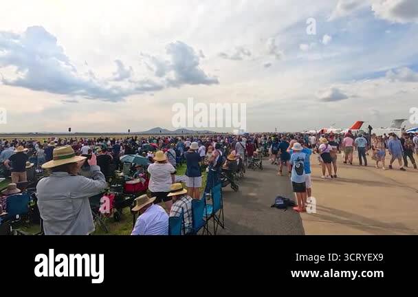 A large crowd gathers under a cloudy sky to watch an airshow in Geelong ...
