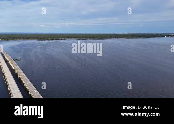 Aerial view of a straight Wright Memorial bridge crossing a tranquil ...