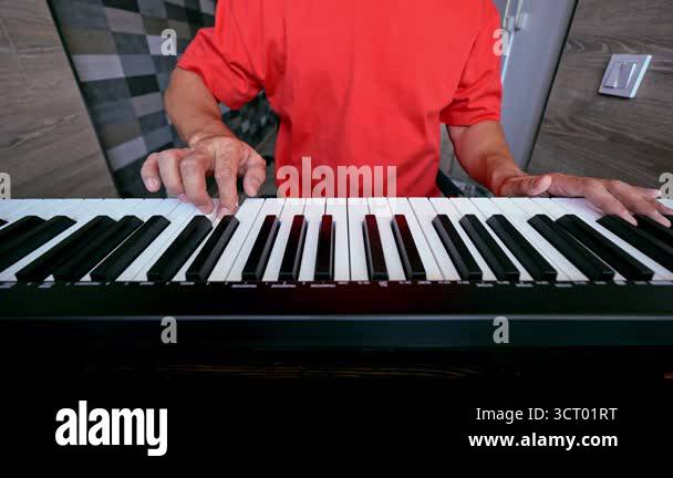 Front view closeup wide angle shot young man in red t-shirt playing ...