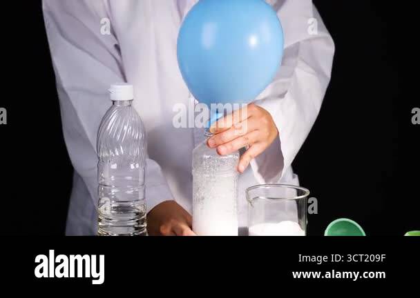 Balloon inflates using chemical reaction in experiment Stock Video ...