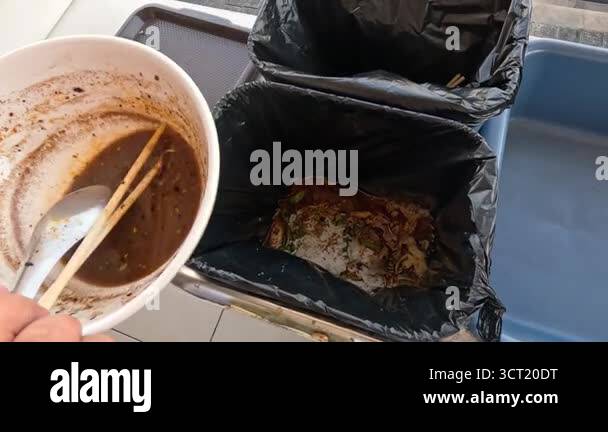 Sequence of discarding food waste into a trash bin Stock Video Footage ...