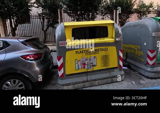 Garbage bins and parked car in Naples, Italy Stock Video Footage - Alamy