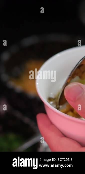 homemade soup boiling in a pot, with vegetables and chicken cooking in ...