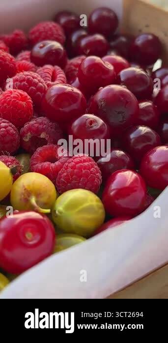 baskets with berries cherry and cargo and raspberries on the windowsill ...