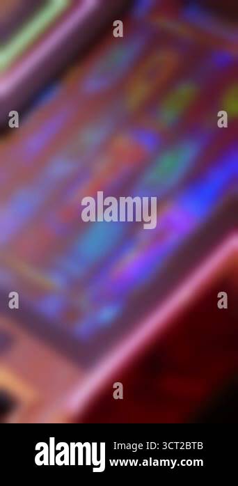 Defocused video of a slot machine screen glowing with colorful lights ...