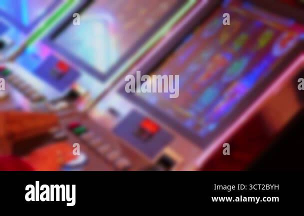 Defocused video of two slot machines glowing with colorful lights and a ...
